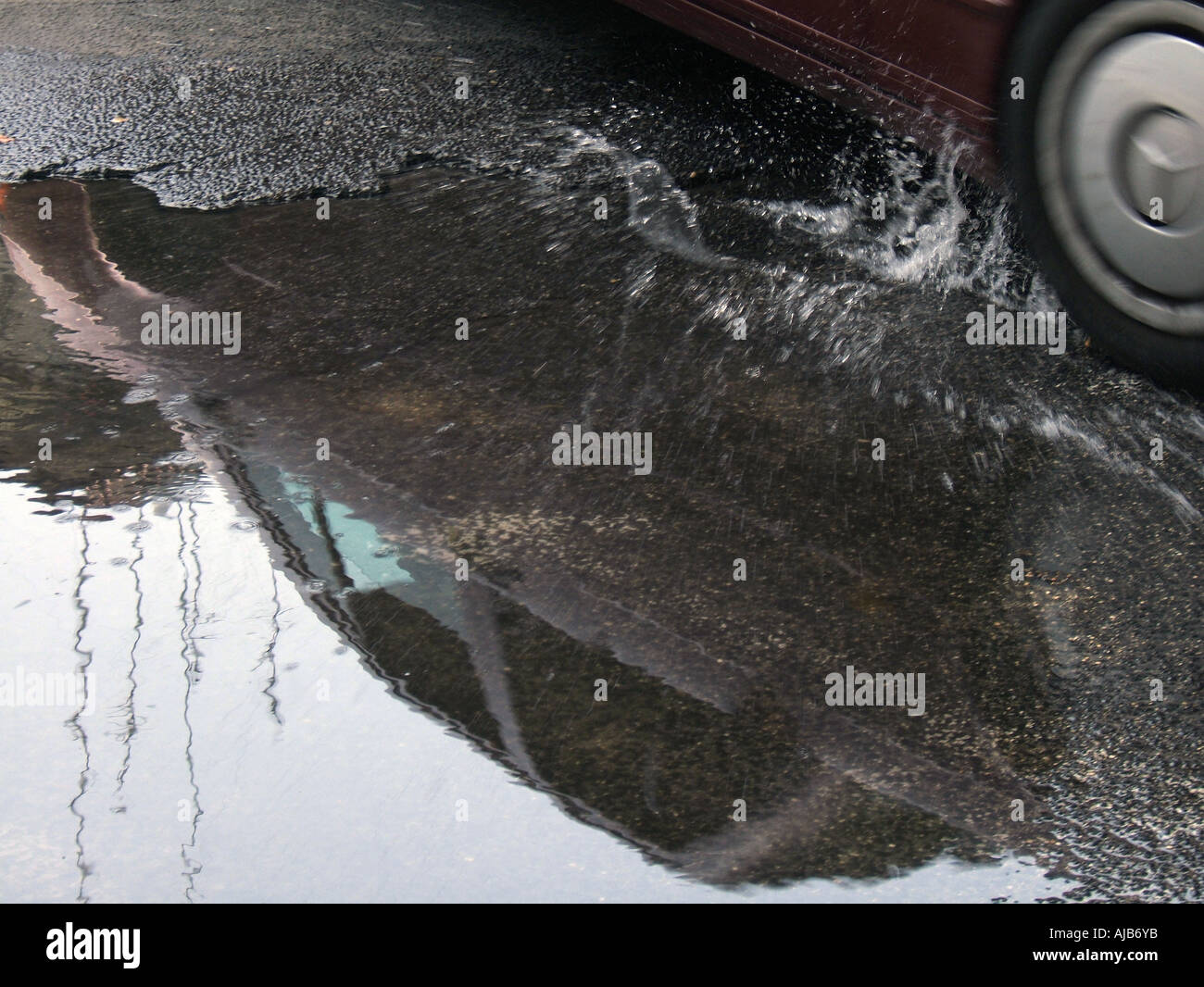 car driving through a pool of water on street Stock Photo - Alamy
