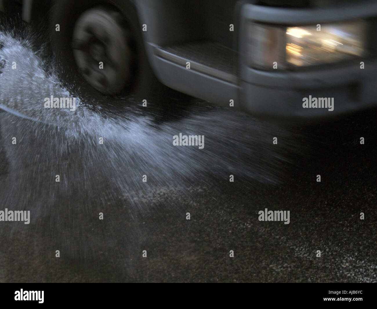 car driving through a pool of water on street Stock Photo - Alamy