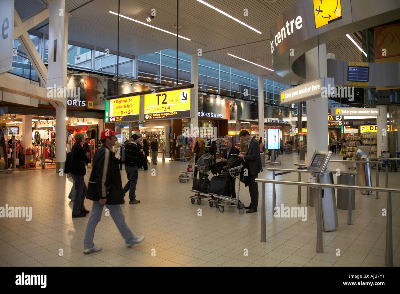 Schiphol shiffol airport terminal building interior and passengers ...