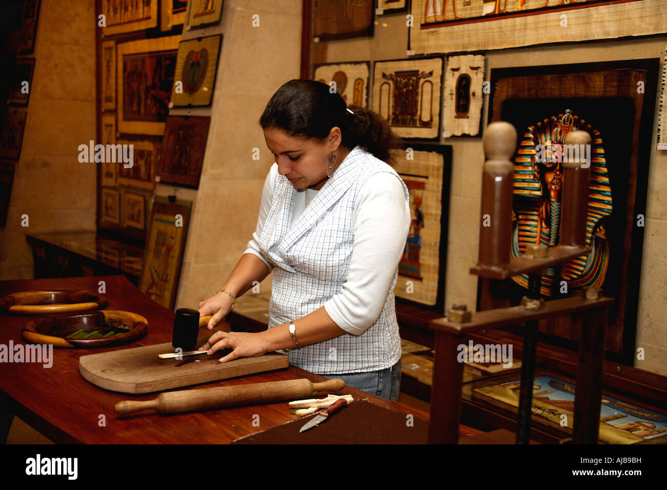 Woman giving demonstration of manufacturing process of Papyrus paper in ...