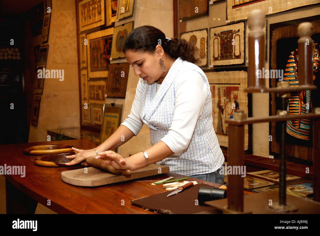 Woman giving demonstration of manufacturing process of Papyrus paper in ...
