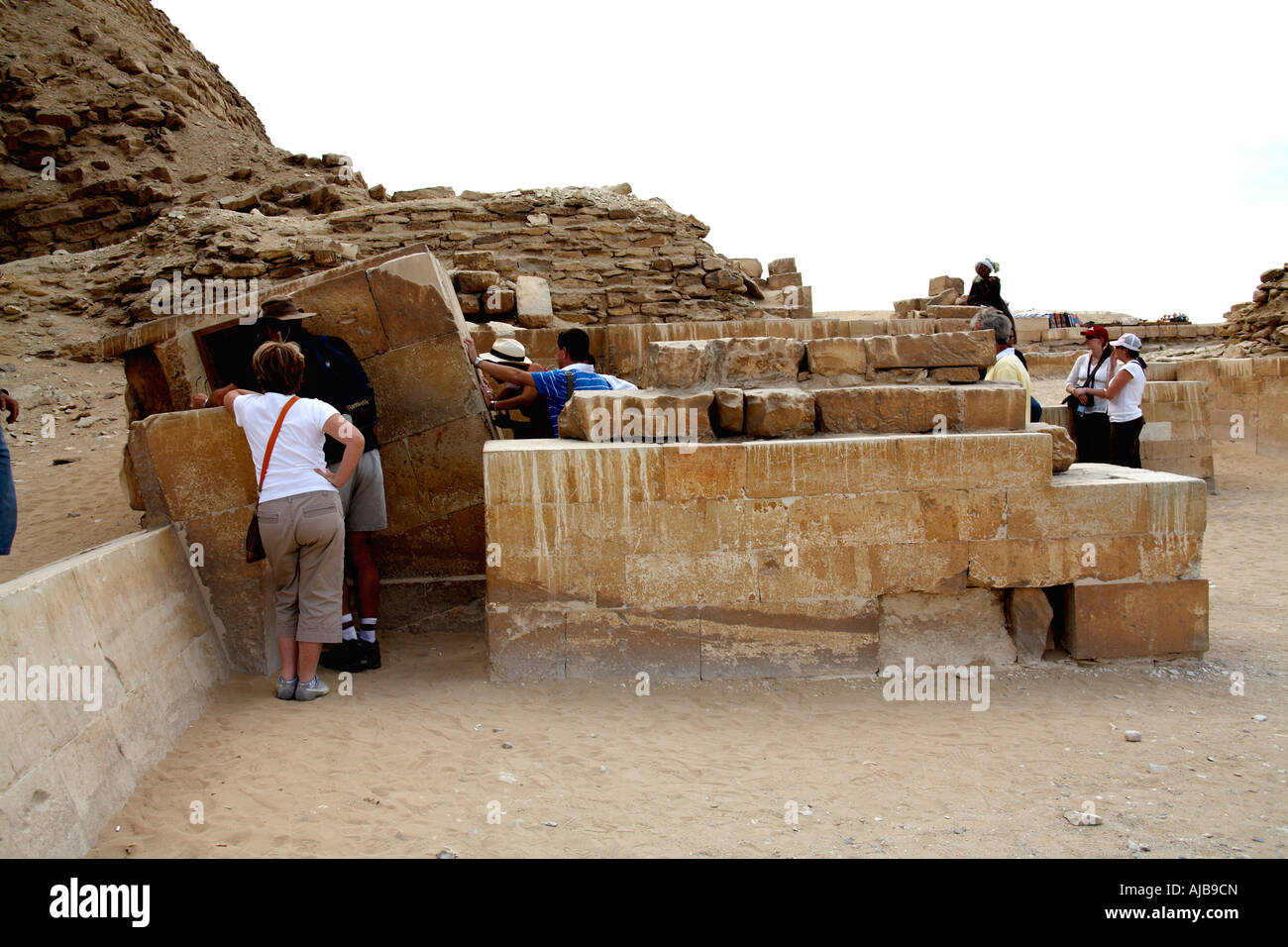 People looking at replica statue of Zoser in Serdab buildings of Zoser ...