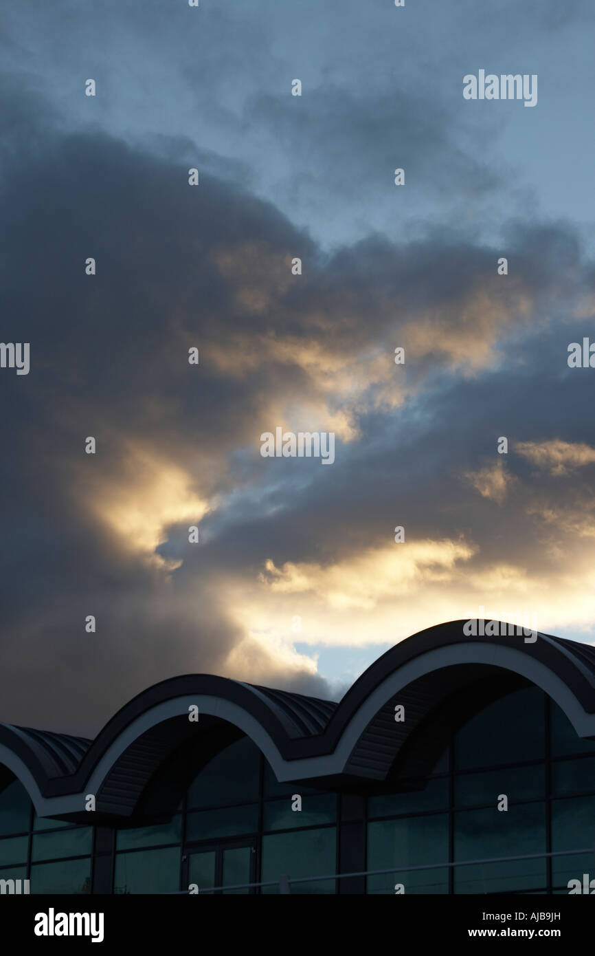 Abstract architectural waveform roof shape of AIS building with sunset ...