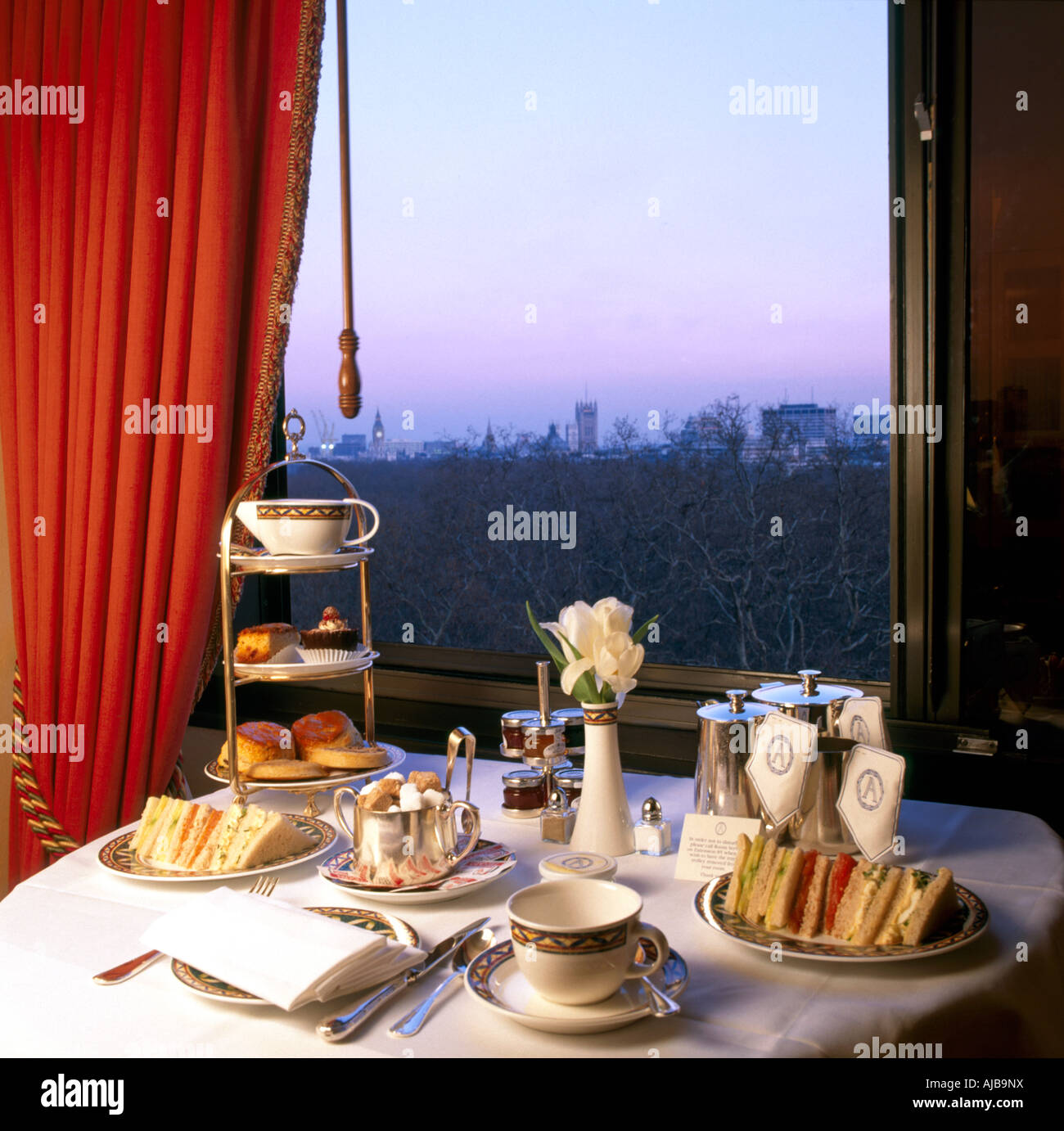 Afternoon tea served with background of London winter evening sky from ...