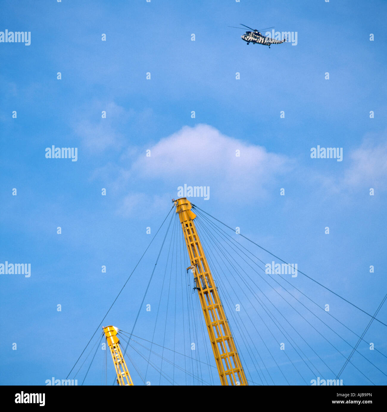 Yellow pylons and cables for roof support on construction site of ...