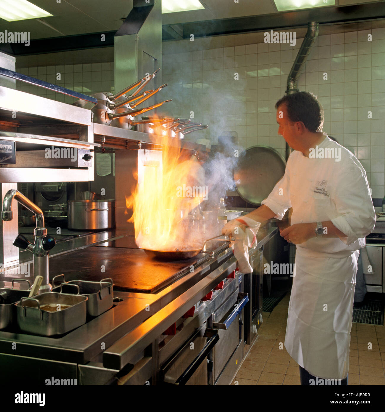 Chef cooking food in with flames in London 101 restaurant London W1 ...