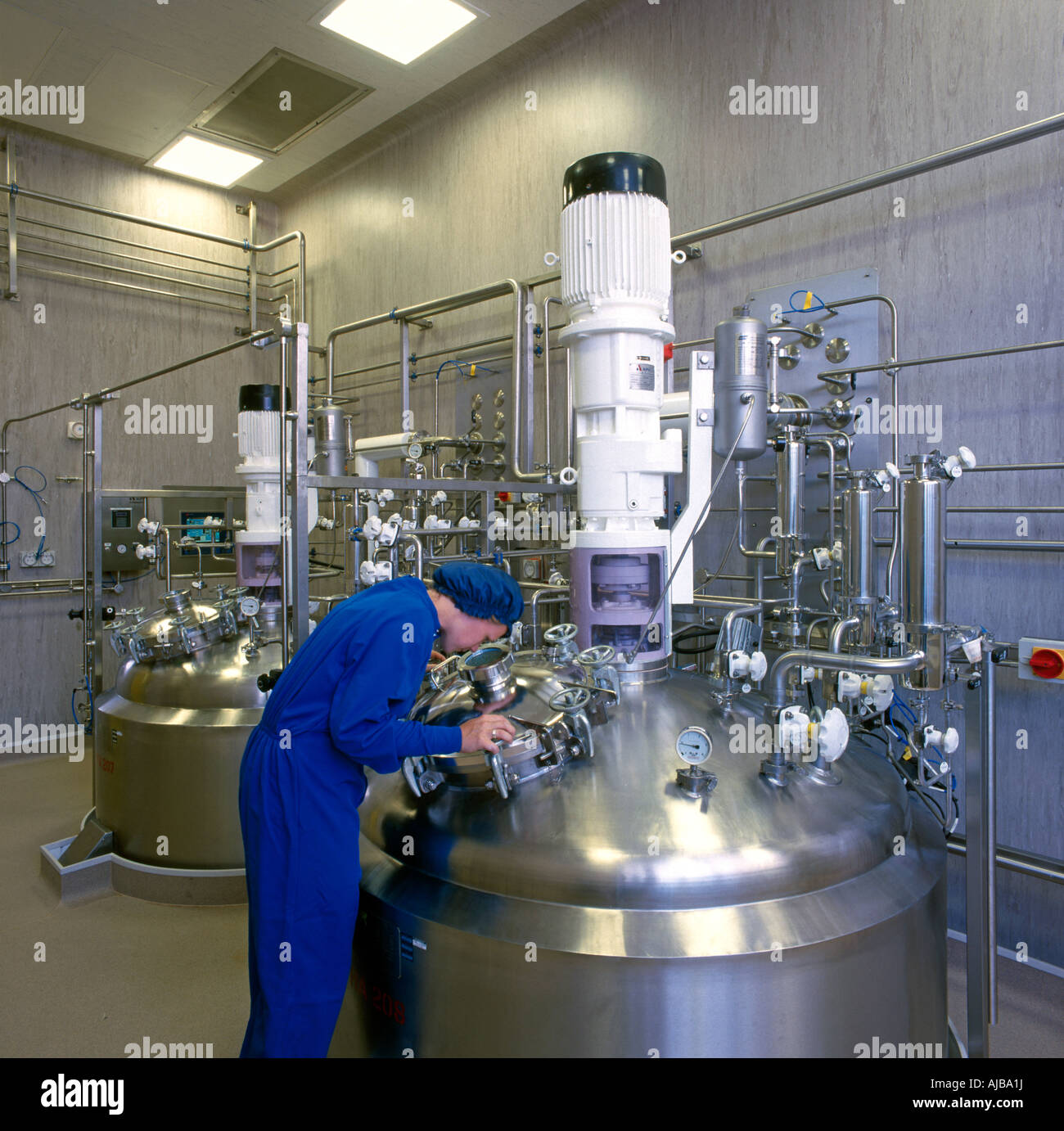 Woman or girl working in industrial process plant laboratory for ...