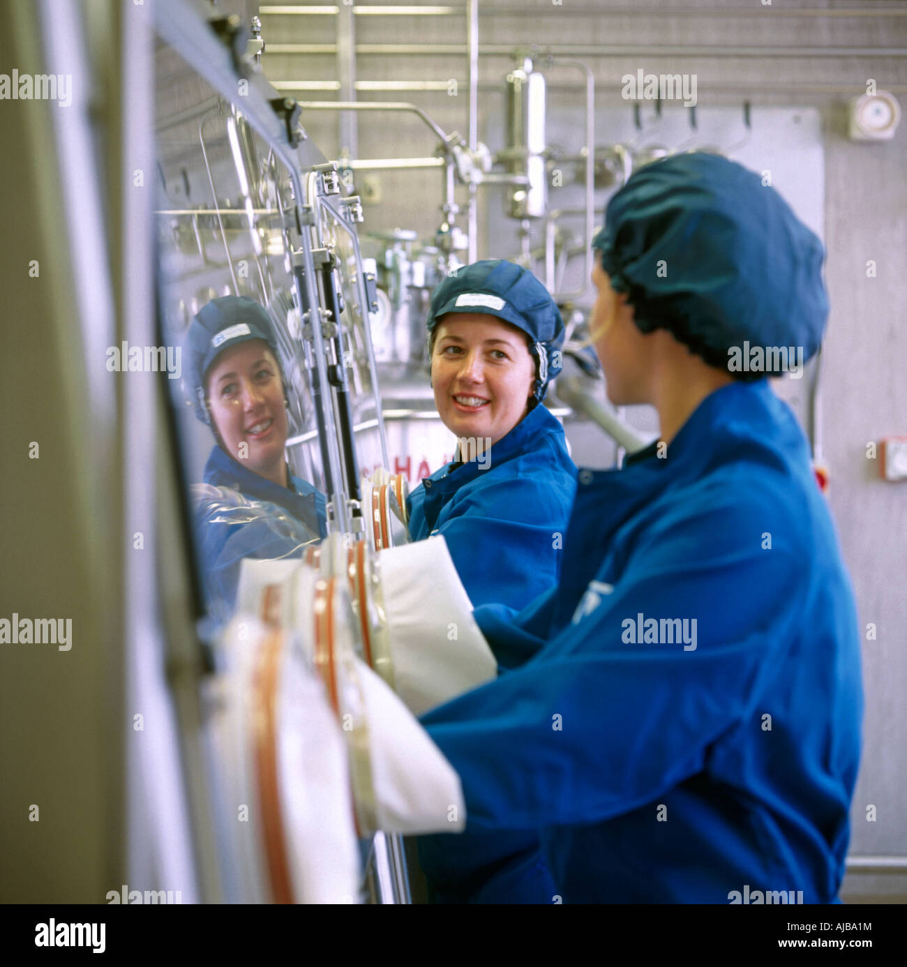 Women working in industrial process plant laboratory for veterinary or ...