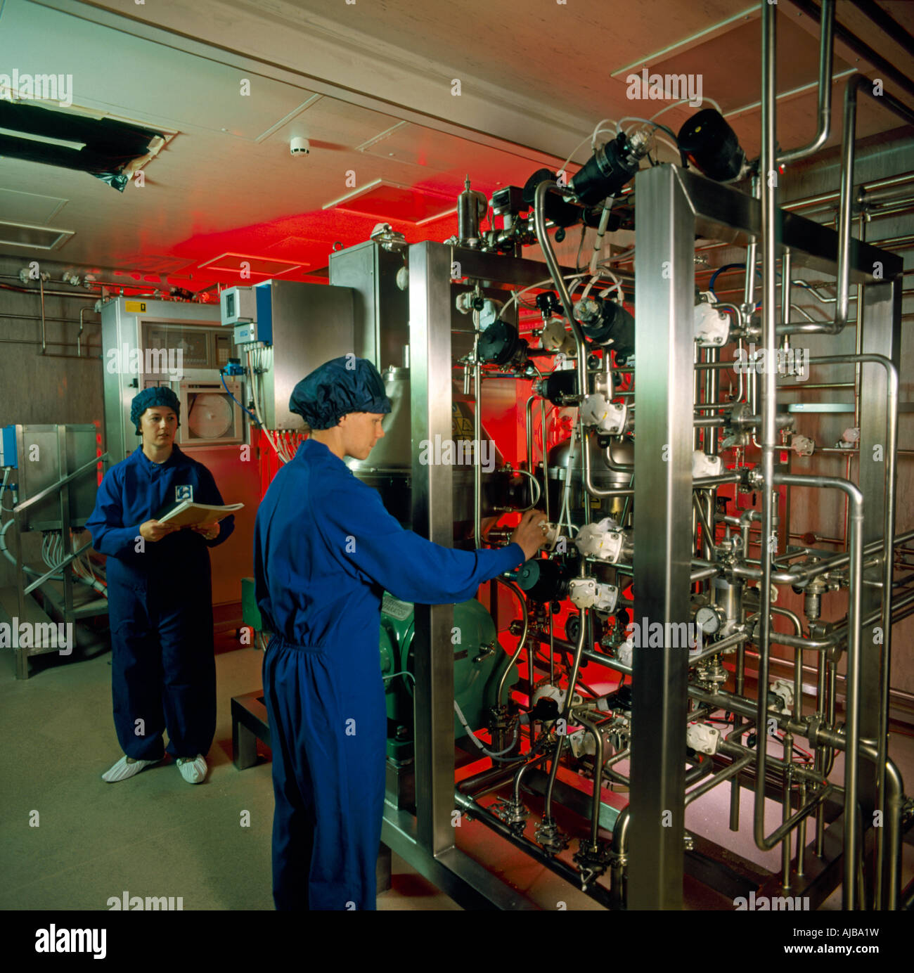Woman or girl working in industrial process plant laboratory for ...