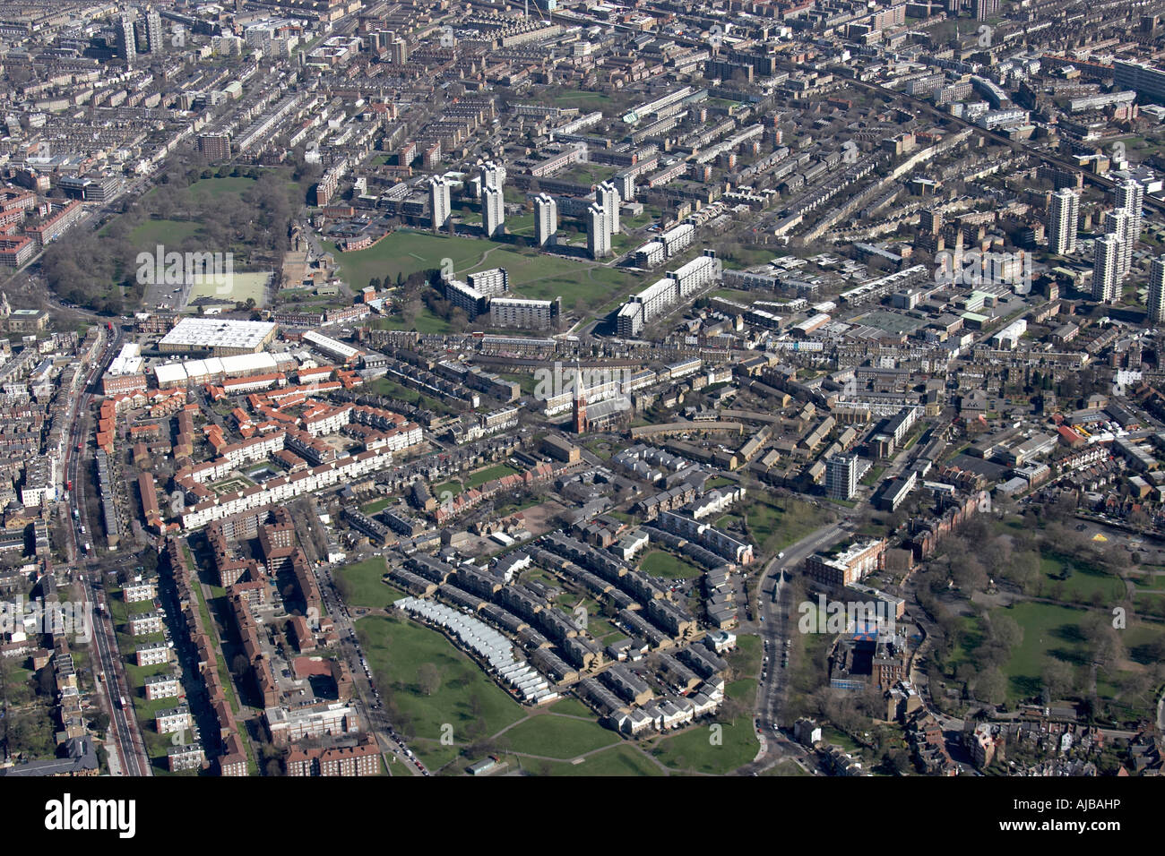 Aerial view north east of suburban houses tower blocks and park ...