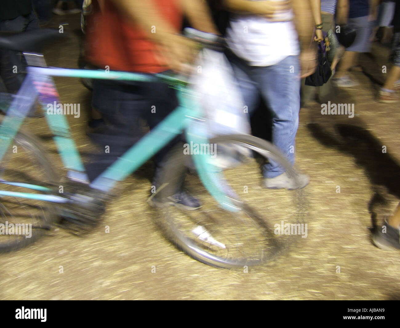 one person pushing bike at gig concert at night Stock Photo - Alamy