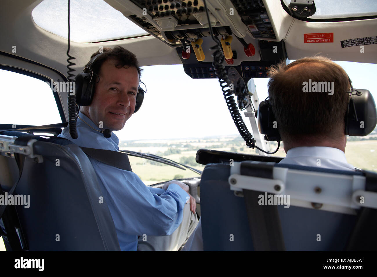 Interior view of Twin Squirrel helicopter smiling passenger and pilot ...