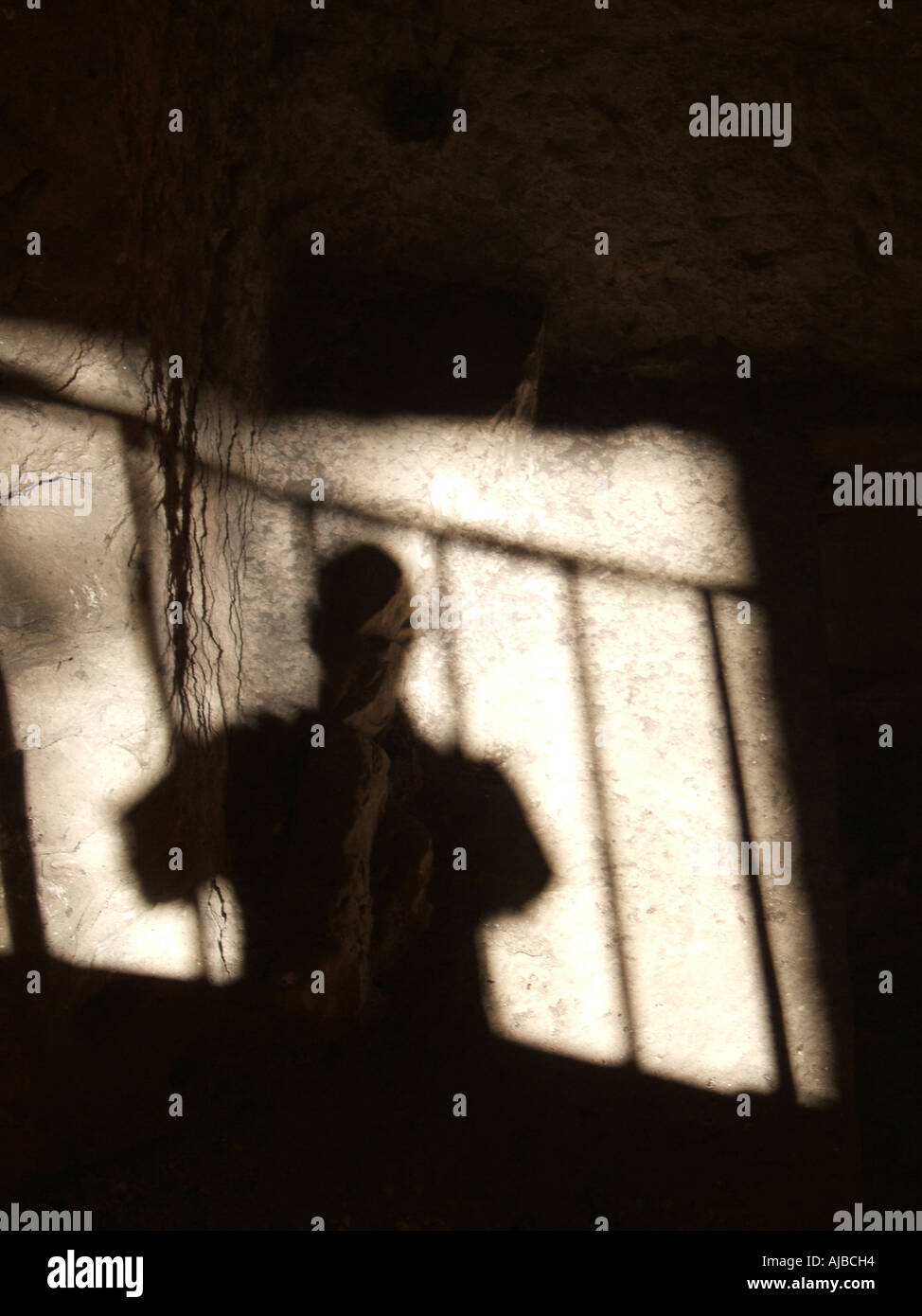 man's shadow on window with bars Stock Photo - Alamy