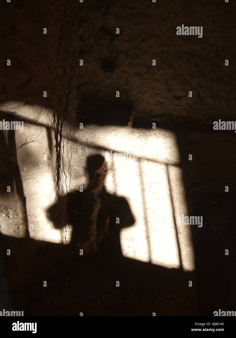 man's shadow on window with bars Stock Photo - Alamy