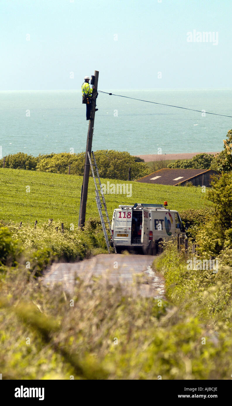 BT openreach engineer working on overhead lines in a country lane on ...