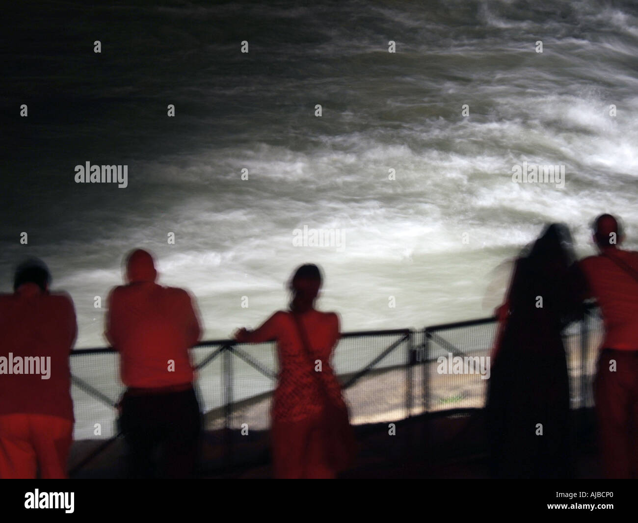 people looking at rough waters at night Stock Photo - Alamy