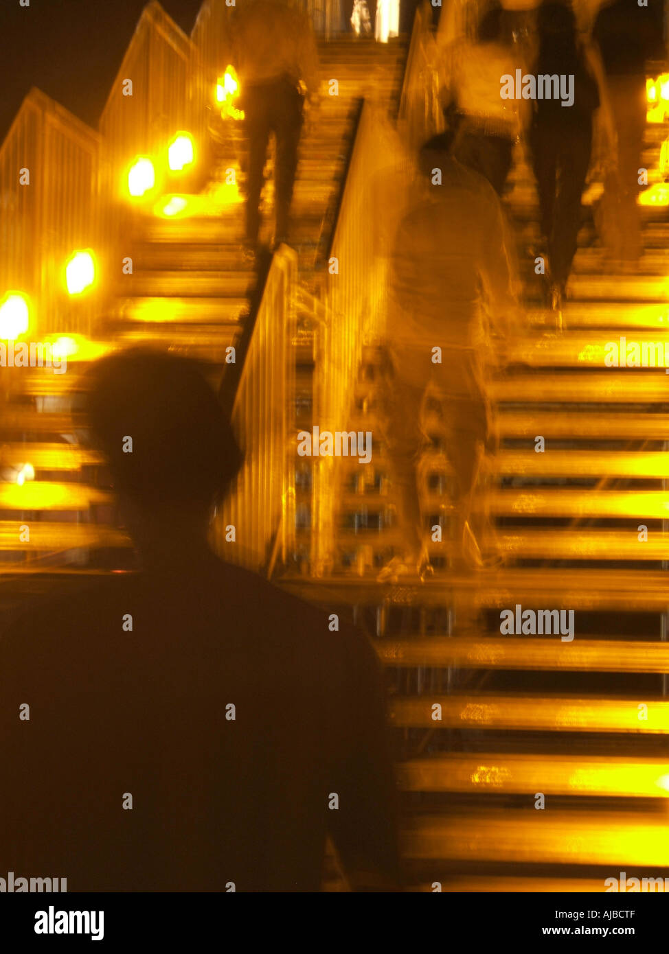 crowd of people walking up steps at night Stock Photo - Alamy