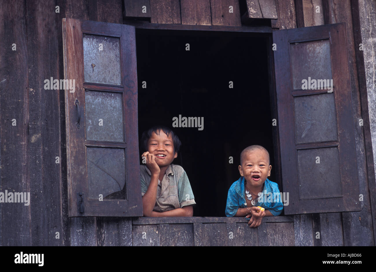 Kids leaning out of the window of a rural monastery in Shwe Mine Bone ...