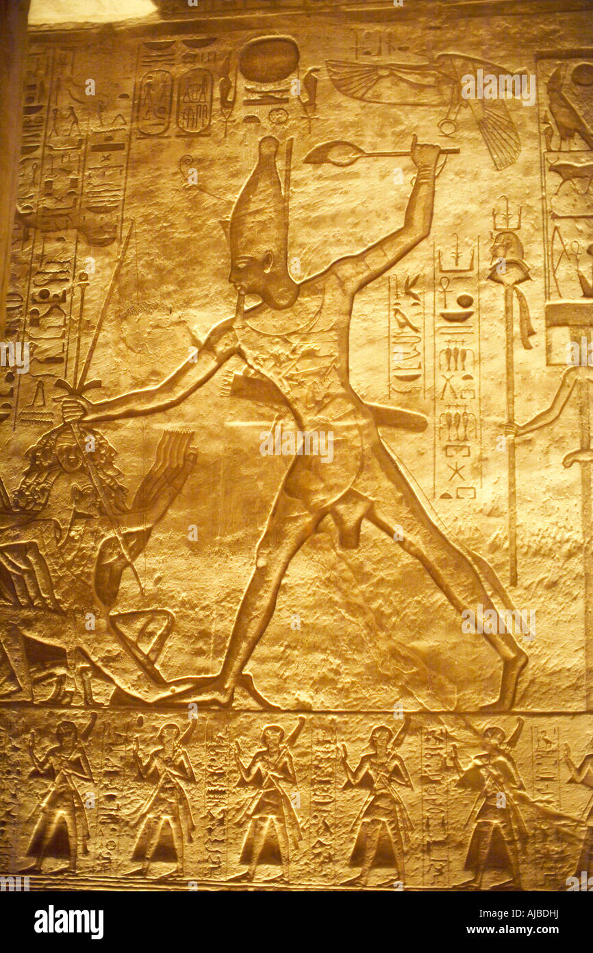 Wall relief carving of Ramses II killing his enemies in the Temple of ...