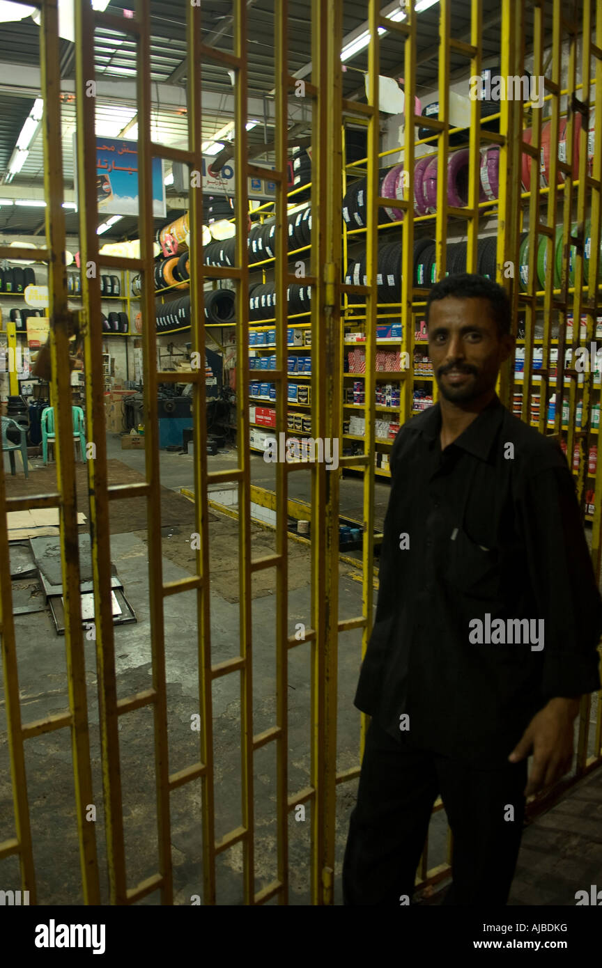 arabic Garage Mechanic outside the shuttered gates of his garage in ...