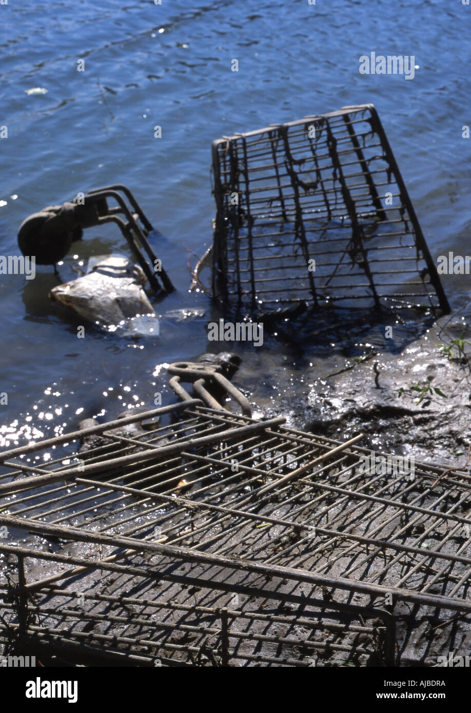 two shopping trolleys dumped in river Stock Photo - Alamy