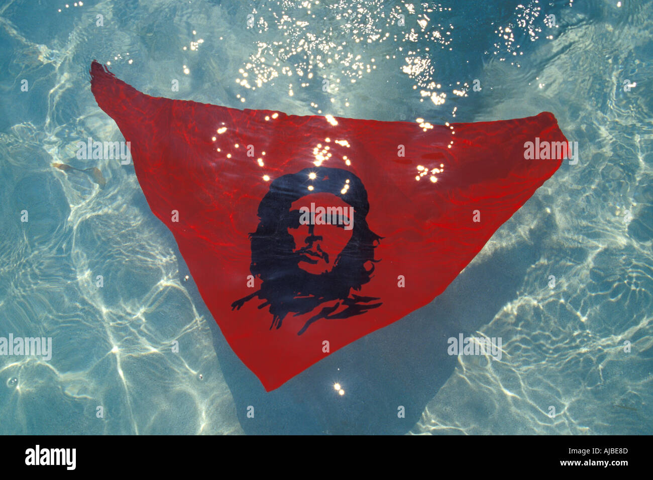 Red scarf depicting Che Guevara floating in the crystal Caribean waters ...