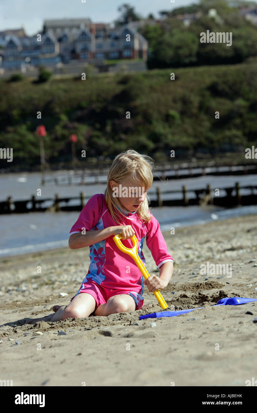 Girl with spade digging in the sand hi-res stock photography and images ...