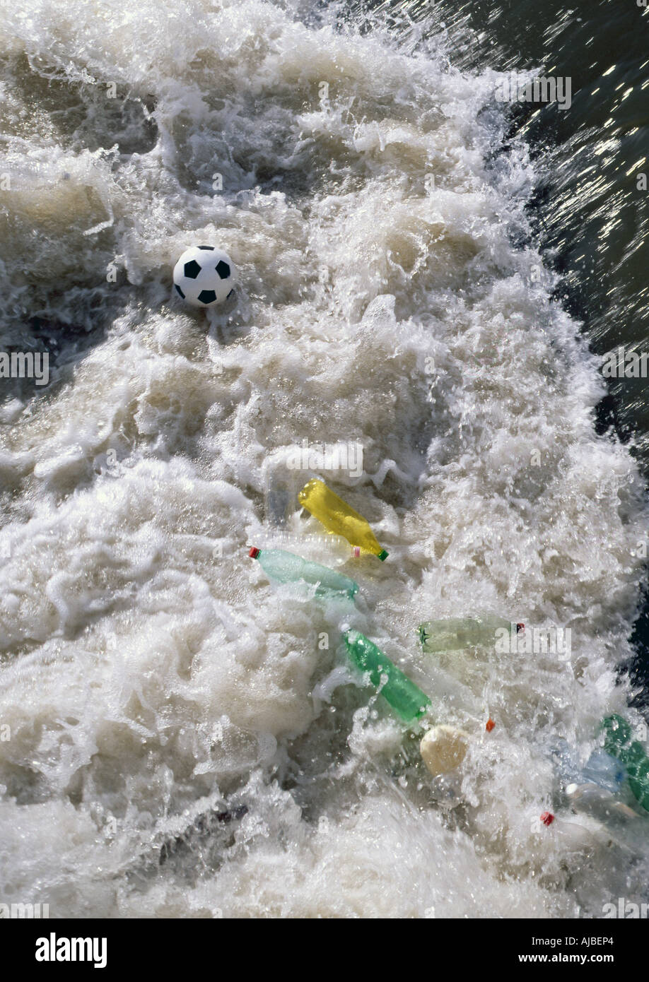 football and rubbish blocked in river waterfall Stock Photo - Alamy