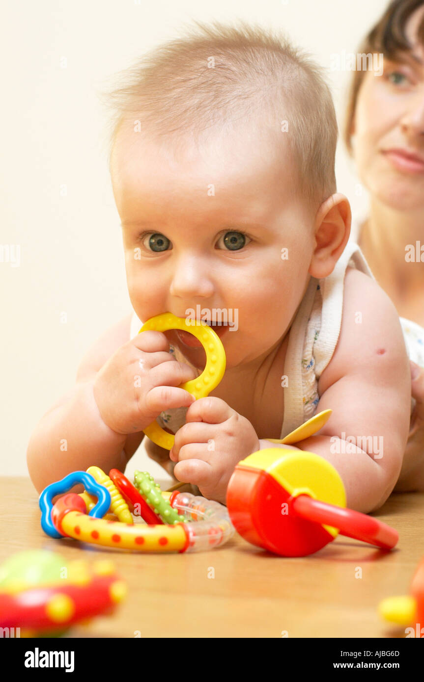 A child biting a toy Stock Photo - Alamy