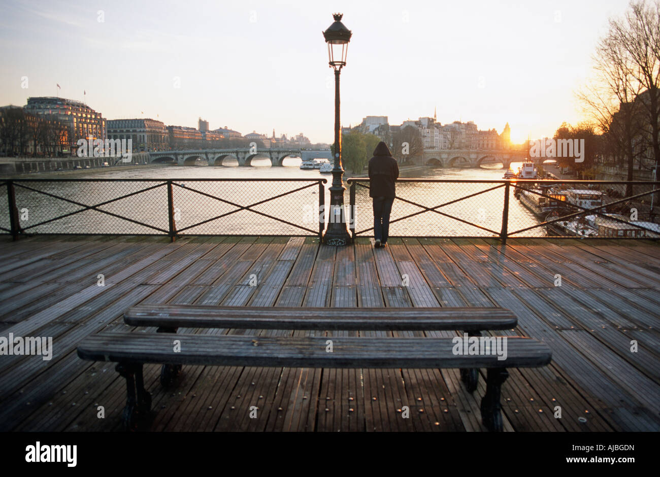 A lone hooded figure stands looking vulnerable while hunched over ...