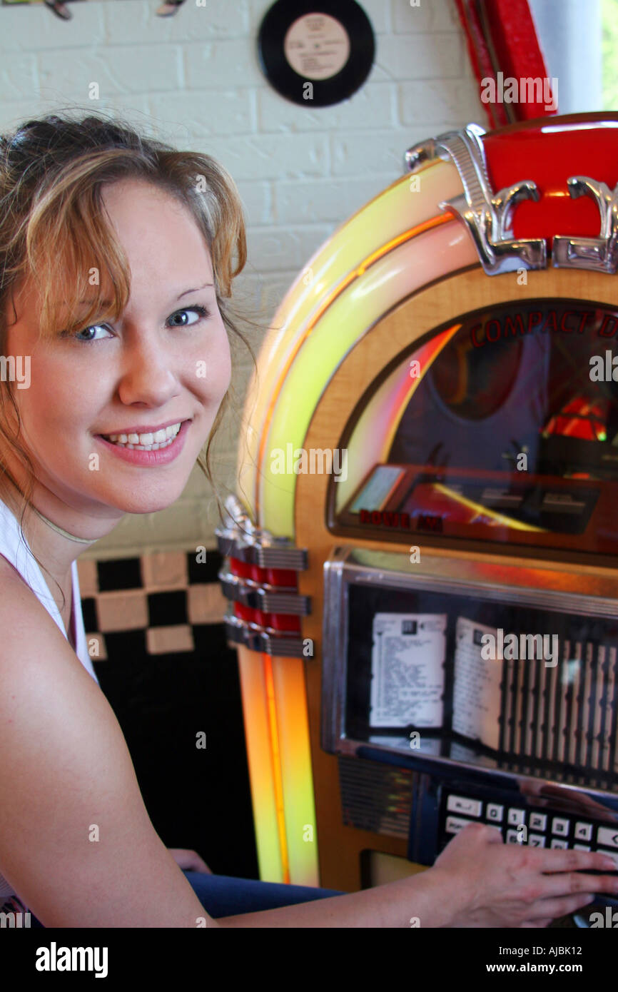 Young Pretty Woman Selecting Favorite Music from Classic Jukebox Stock ...