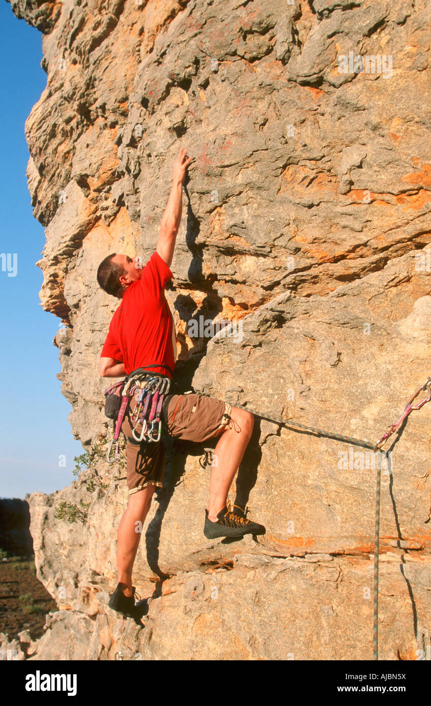 Man Climbing Cliff Face Stock Photo - Alamy