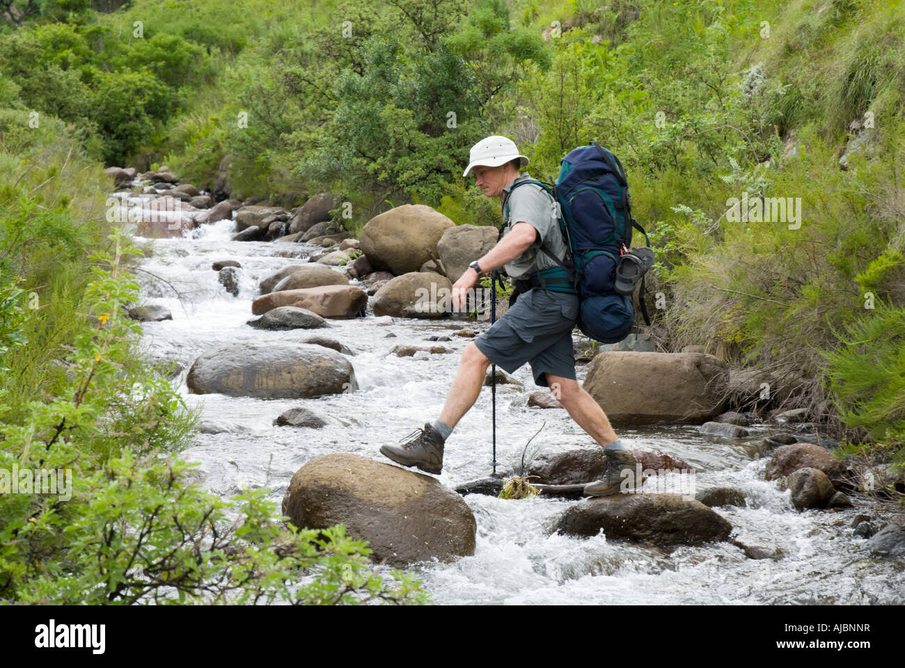 Hiker Boulder Hopping Across a River Stock Photo - Alamy