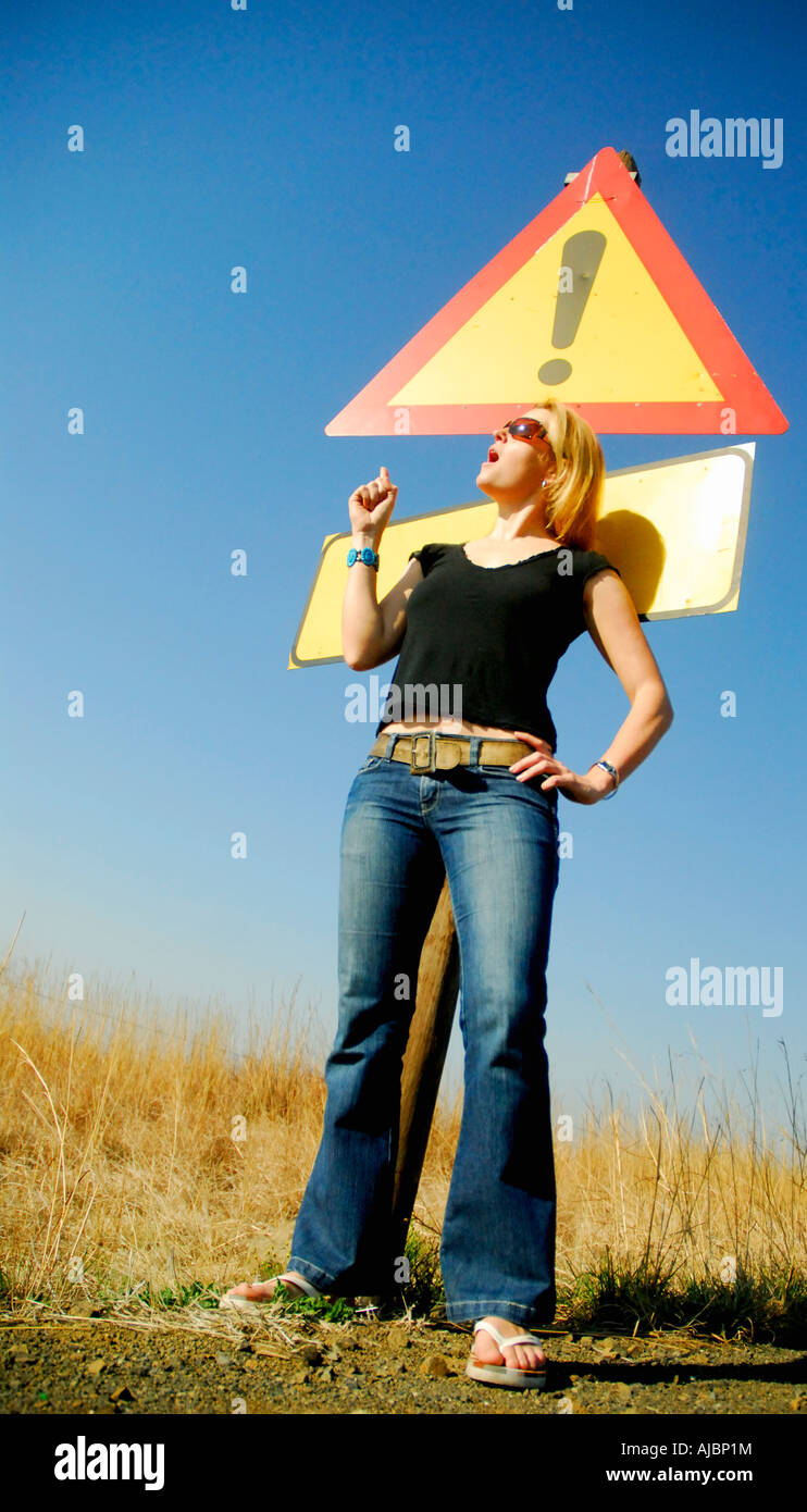 Women Standing in Front of Warning Road Sign Stock Photo - Alamy