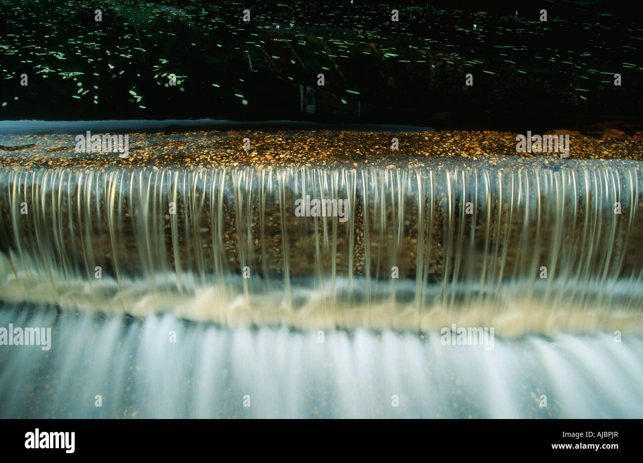 Scenic View of Water Flowing Over Weir Stock Photo - Alamy