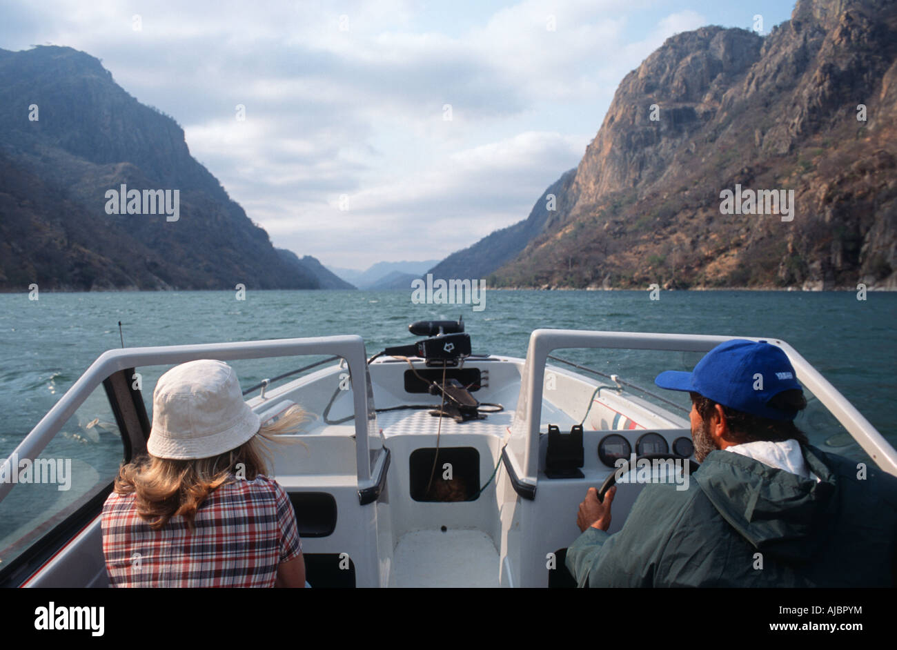 Couple in a Speedboat on a Lake Heading Towards Cliffs Stock Photo - Alamy