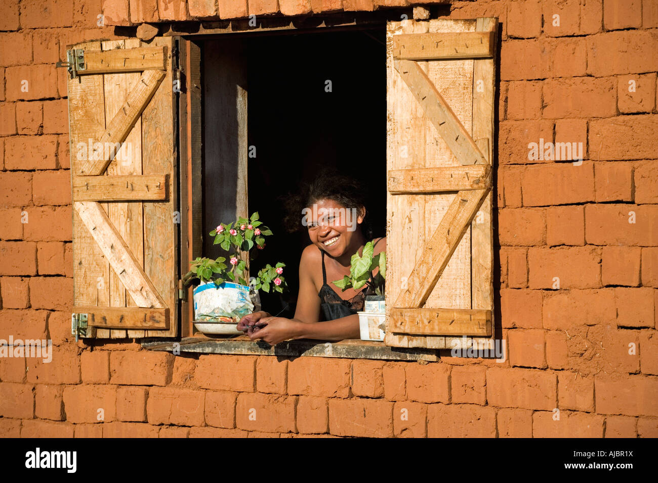 Young Women Leaning Out of Window Stock Photo - Alamy