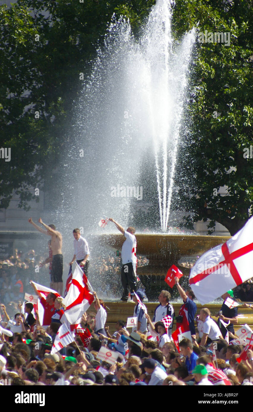 crowds of fans dancing in the fountains in Trafalgar Square London ...