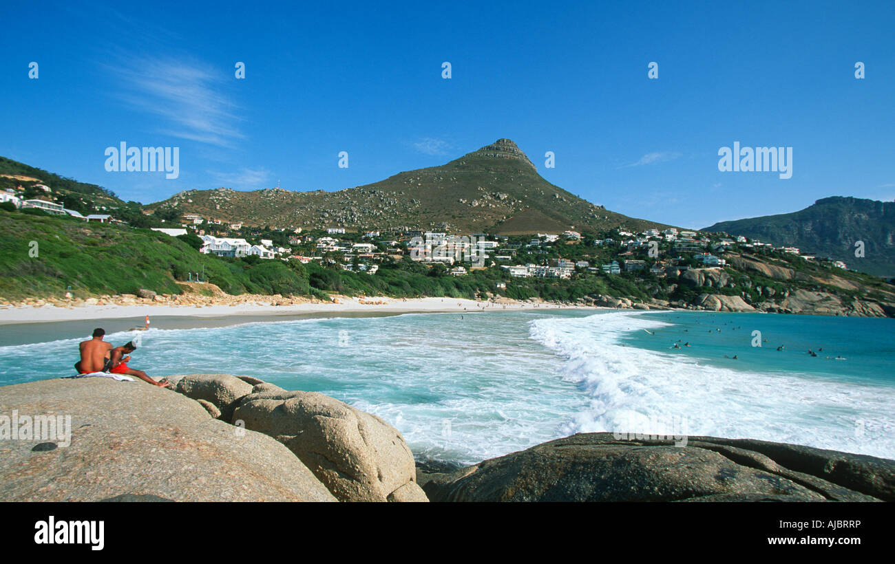 Sunbathers Sitting on Rocks at Llandudno Beach Stock Photo - Alamy