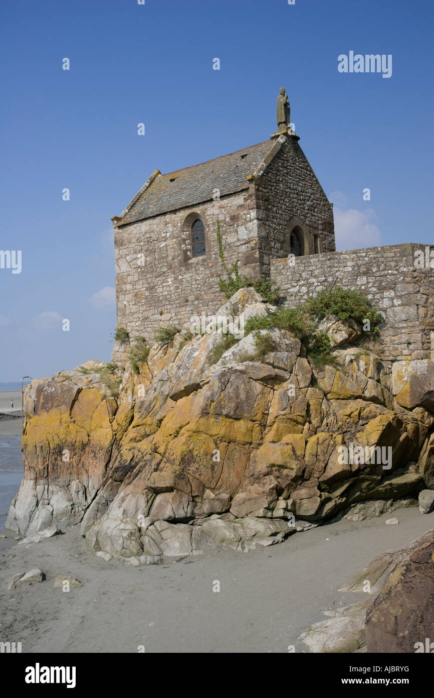 Small stone church on rock outcrop behind Mont Saint Michel Brittany ...