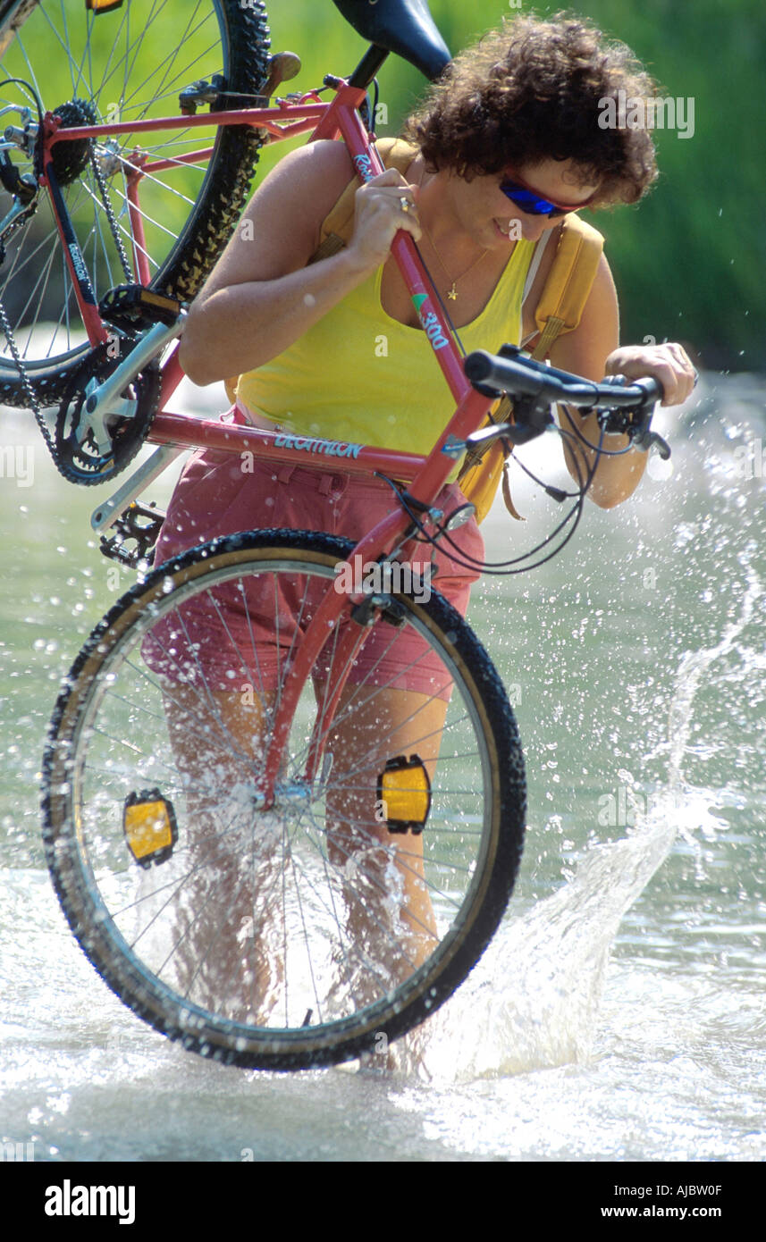 Woman with bicycle on shoulder hi-res stock photography and images - Alamy