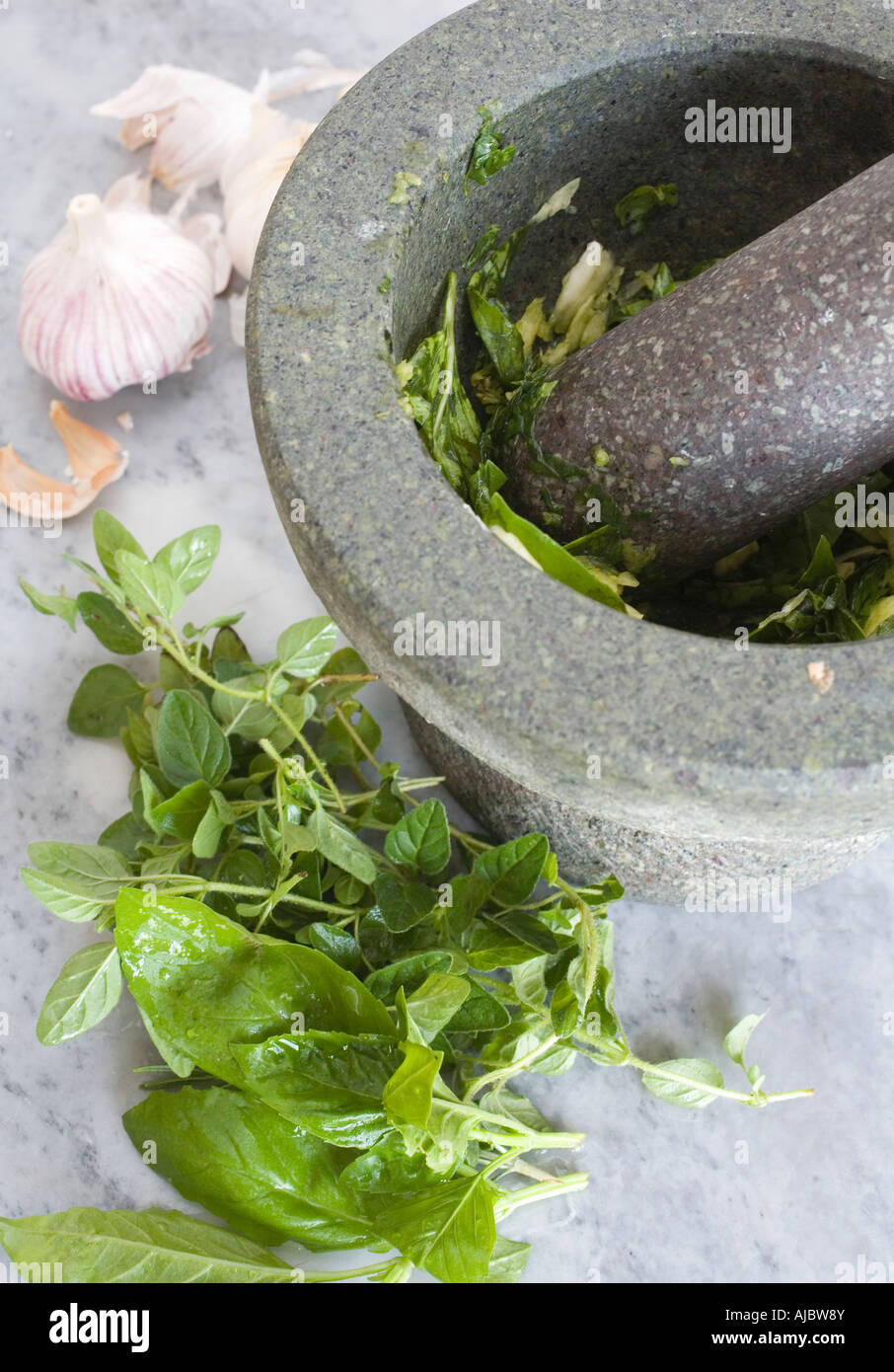 High Angle View of a Mortar and Pestle with Garlic and Herbs Stock ...