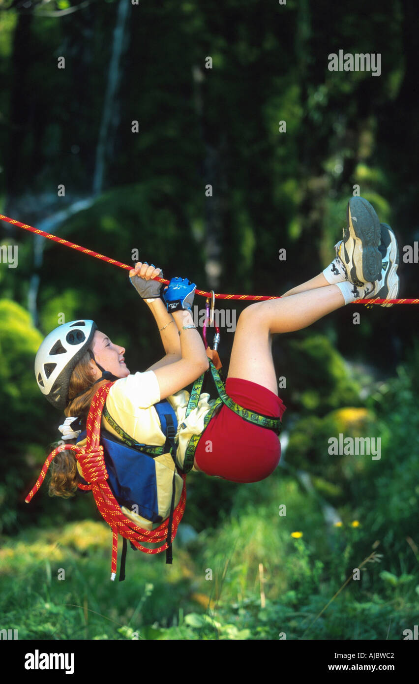 girl hanging at a rope, wearing cycling helmet and backpack Stock Photo ...