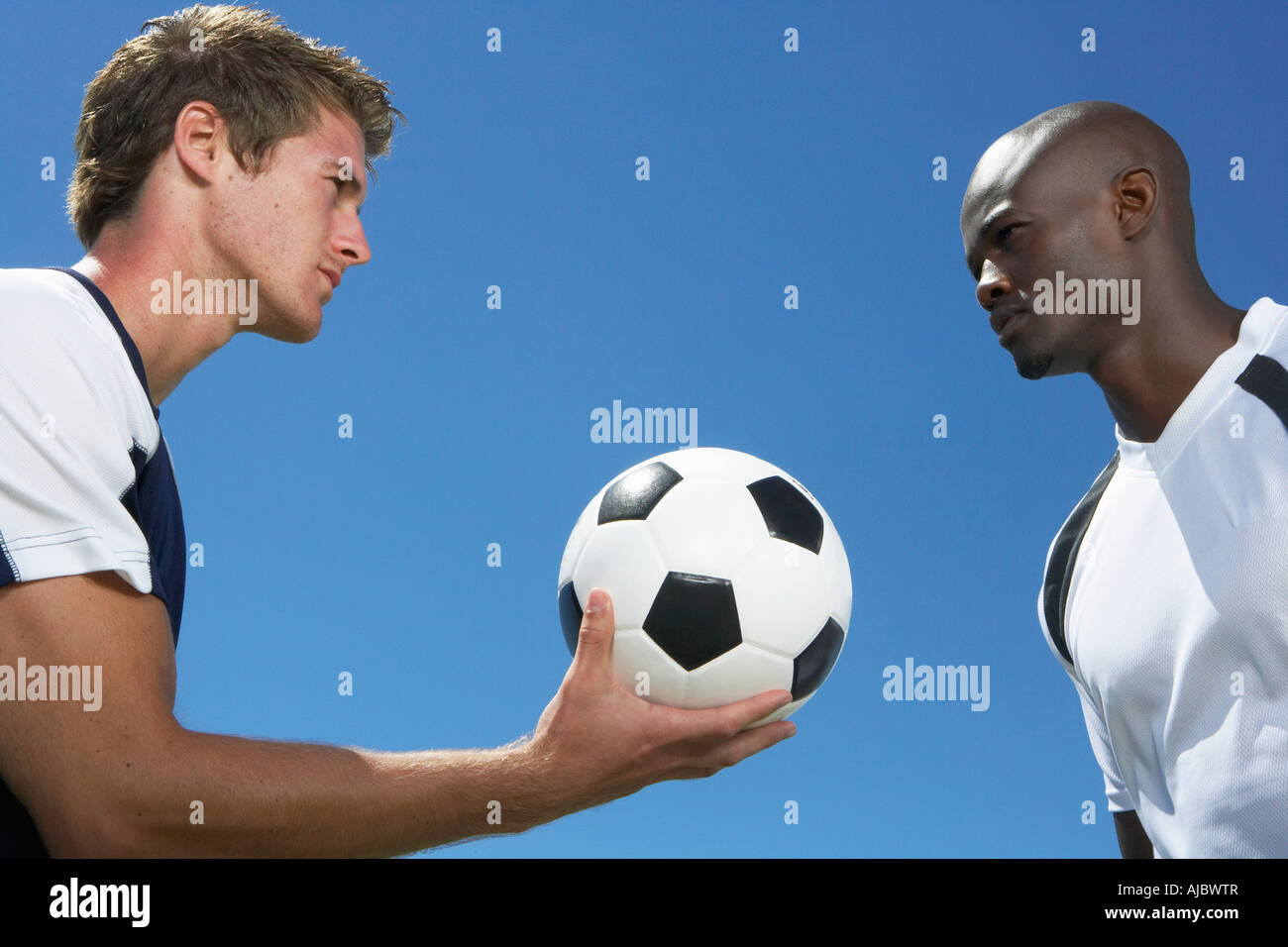 Two Men Face to Face and Holding Soccer Ball Stock Photo - Alamy