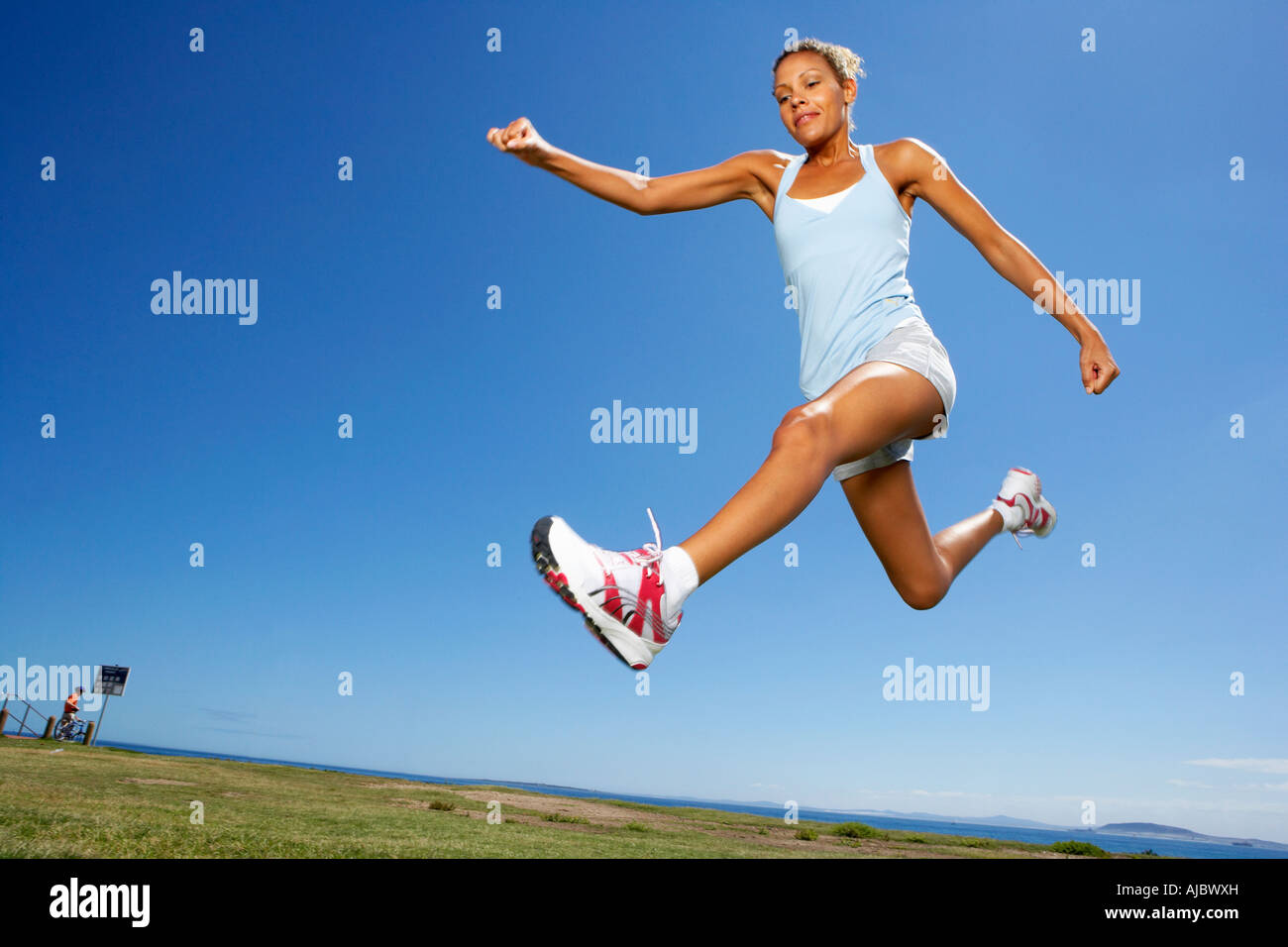 Portrait of a Female Athlete Jumping Stock Photo - Alamy