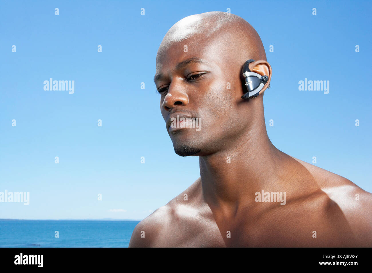 Portrait of Man Listening to Ear Piece Stock Photo - Alamy