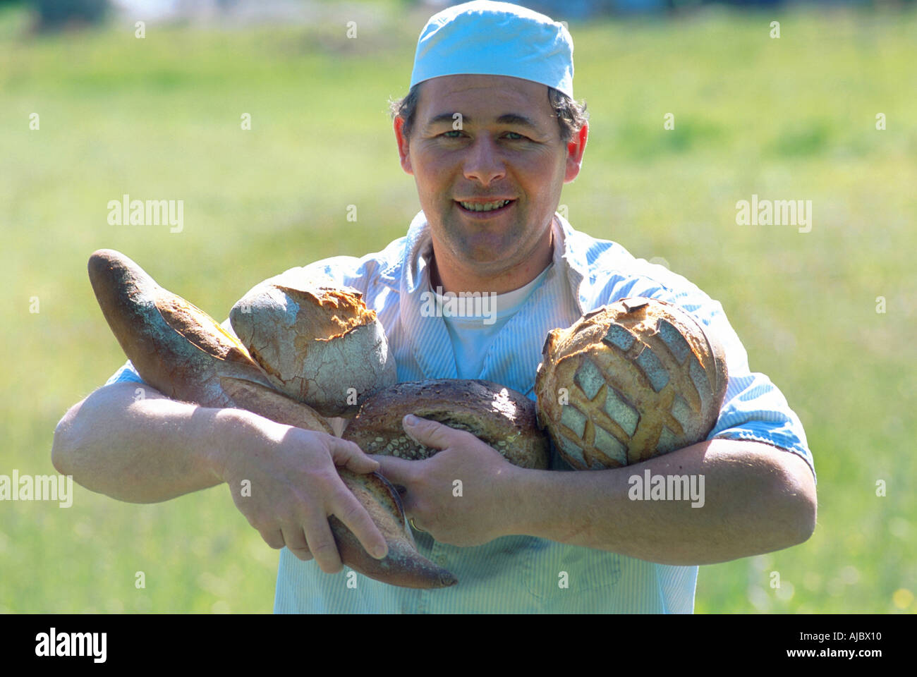 baker, holding breads in his arms Stock Photo - Alamy