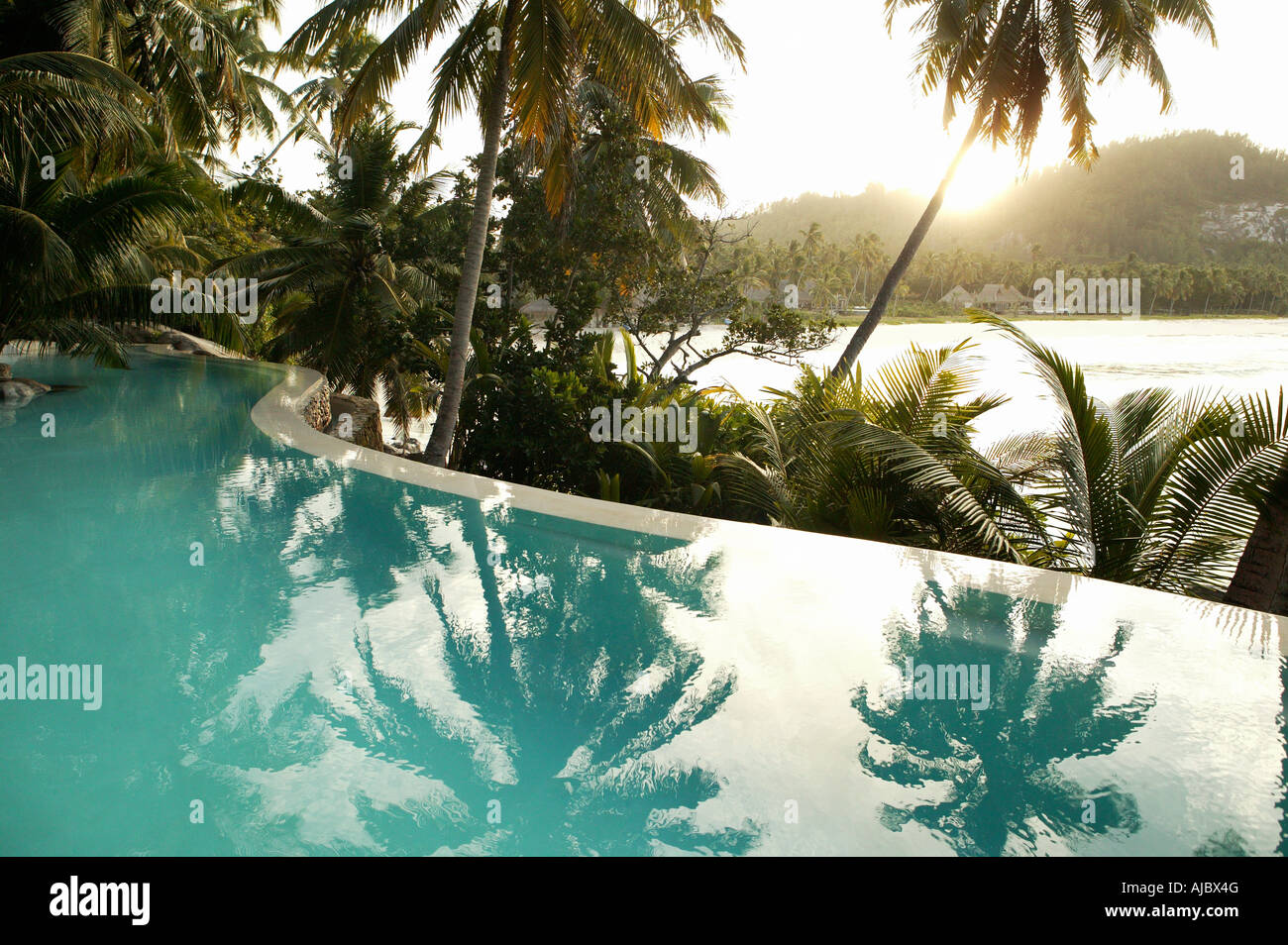 Infinity Pool Overlooking a Pristine Beach Stock Photo - Alamy
