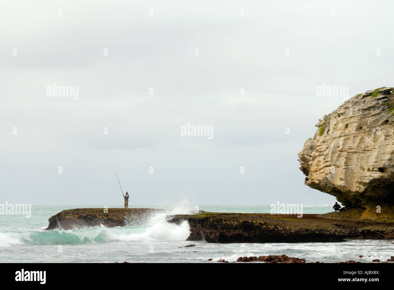 Fisherman Fishing on a Rock Outcrop Stock Photo - Alamy