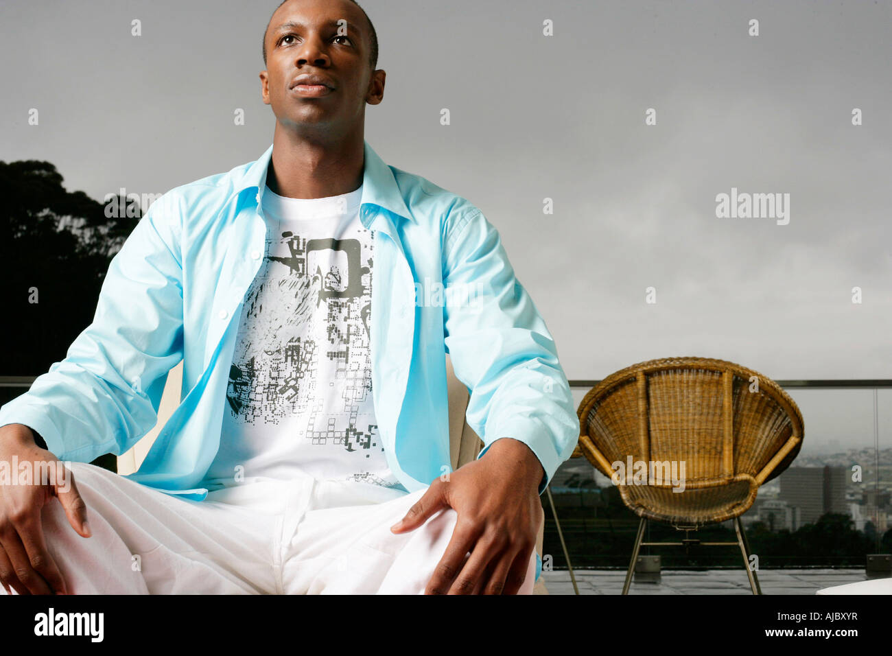 Portrait of an African Man Sitting on a Chair Stock Photo - Alamy